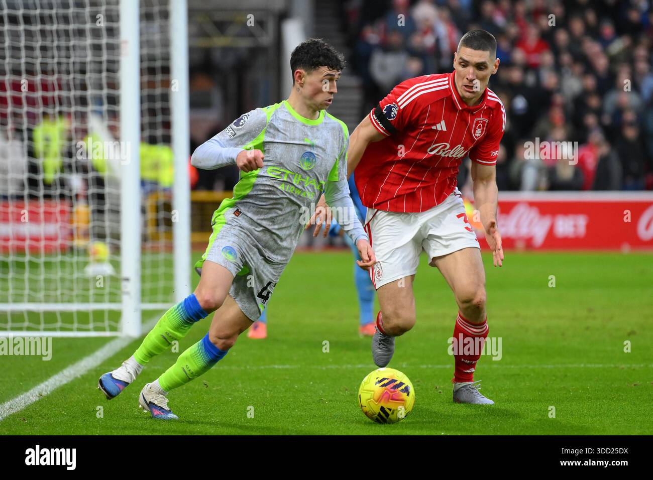 Phil Foden of Manchester City under pressure from Nikola Milenkovic of ...