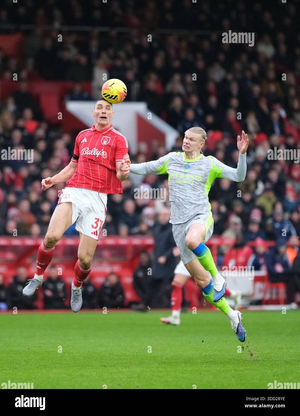 Nikola Milenkovic of Nottingham Forest heads clear under pressure from ...