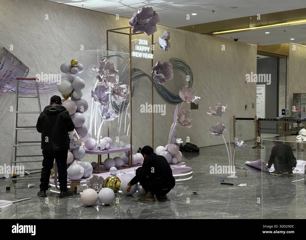 Workers prepare a display welcoming 2026 in the lobby of the LG Towers ...