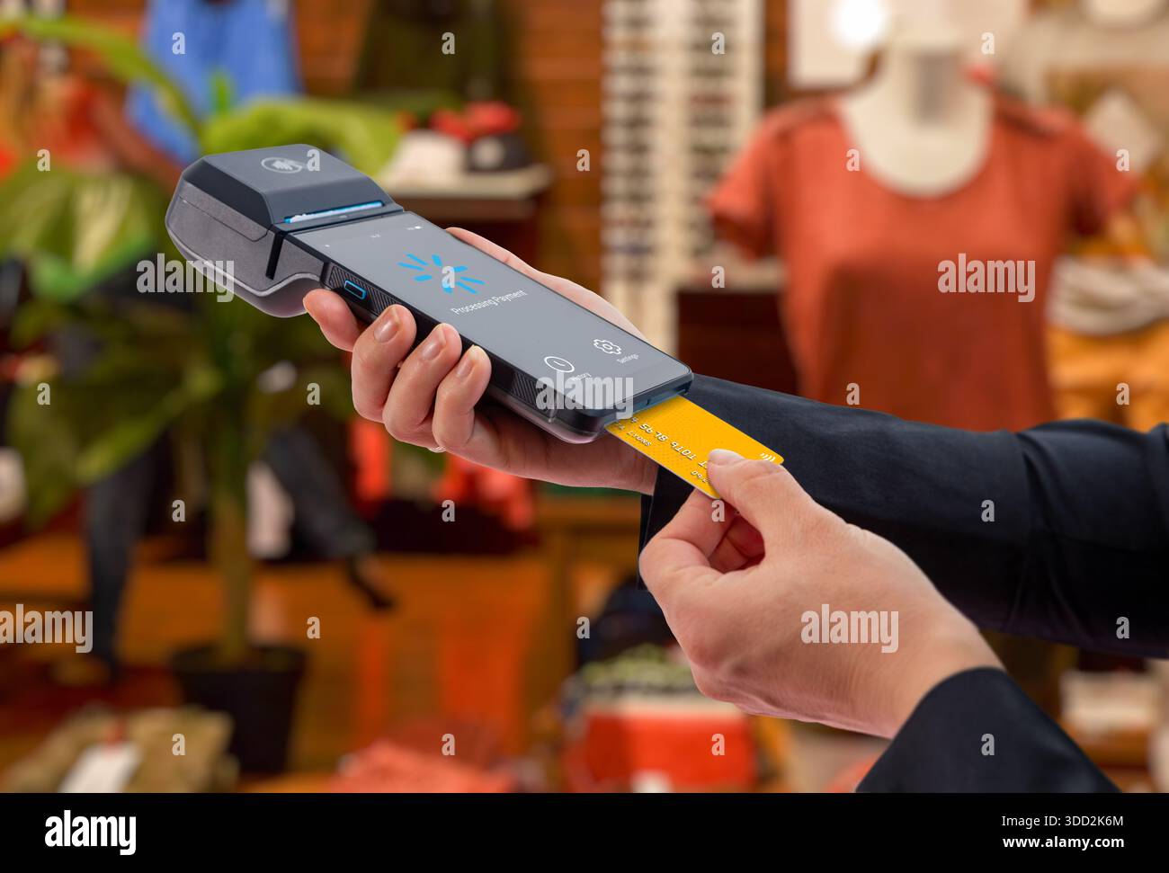 Customer inserting payment card into portable POS terminal in retail ...