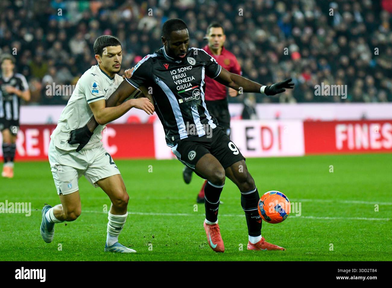 Udinese's Keinan Davis in action hindered by Lazio's Reda Belahyane ...