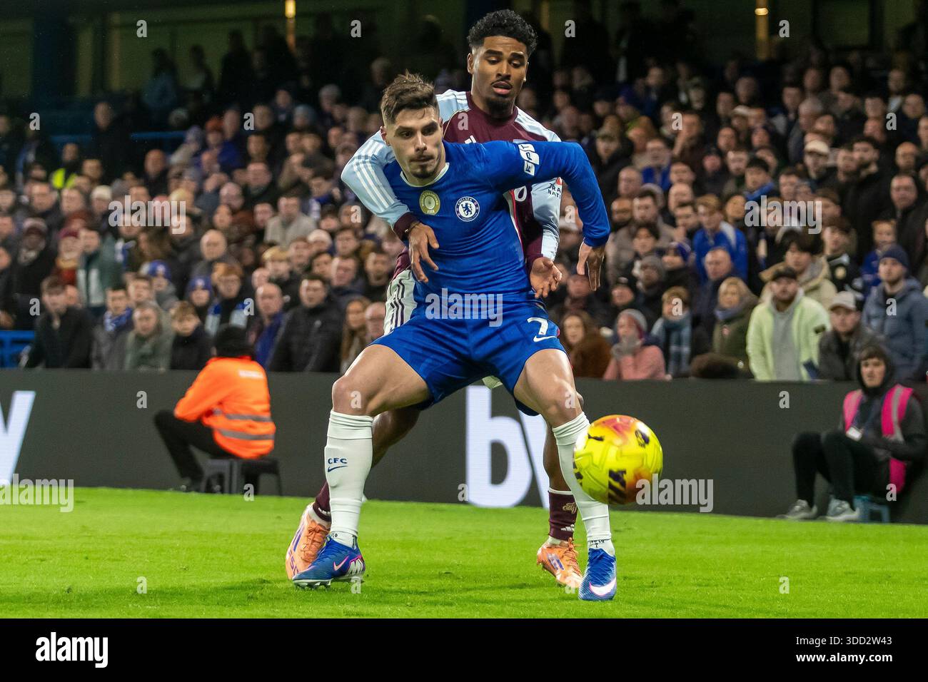 Pedro Neto of Chelsea and Ian Maatsen of Aston Villa battle for the ...