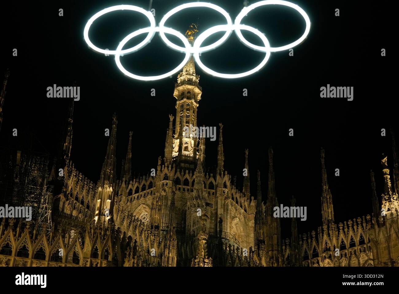 Neon Olympic rings hang next to the Duomo gothic cathedral for the ...