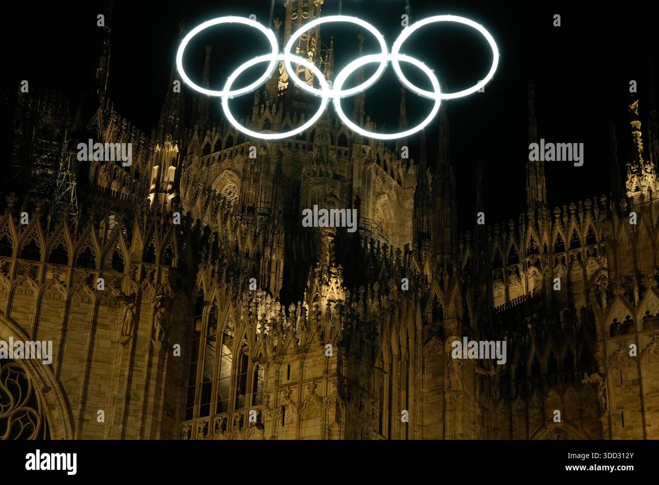 Neon Olympic rings hang next to the Duomo gothic cathedral for the ...