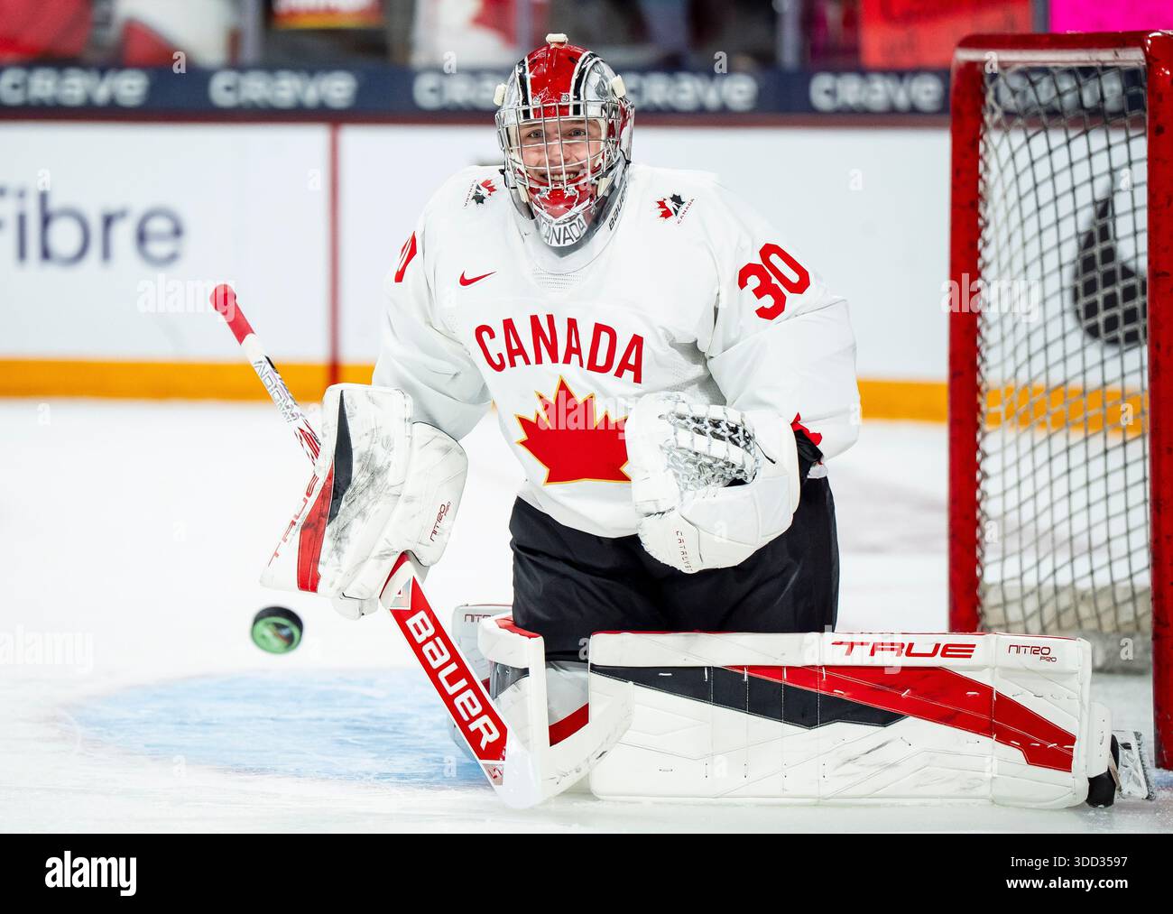 Canada goaltender Carter George (30) smiles as he warms up before IIHF ...