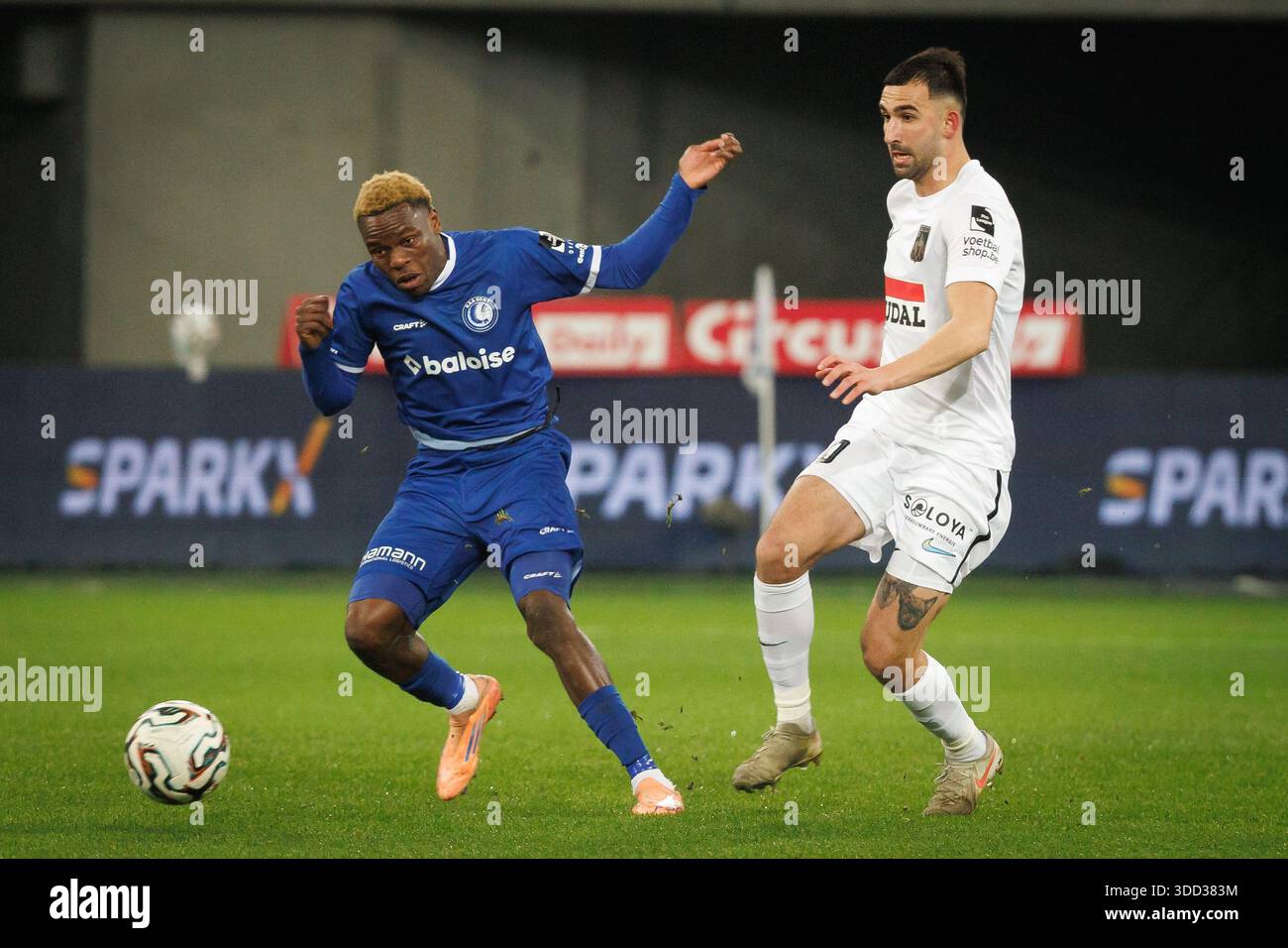 Gent's Hyllarion Goore and Westerlo's Emin Bayram fight for the ball ...