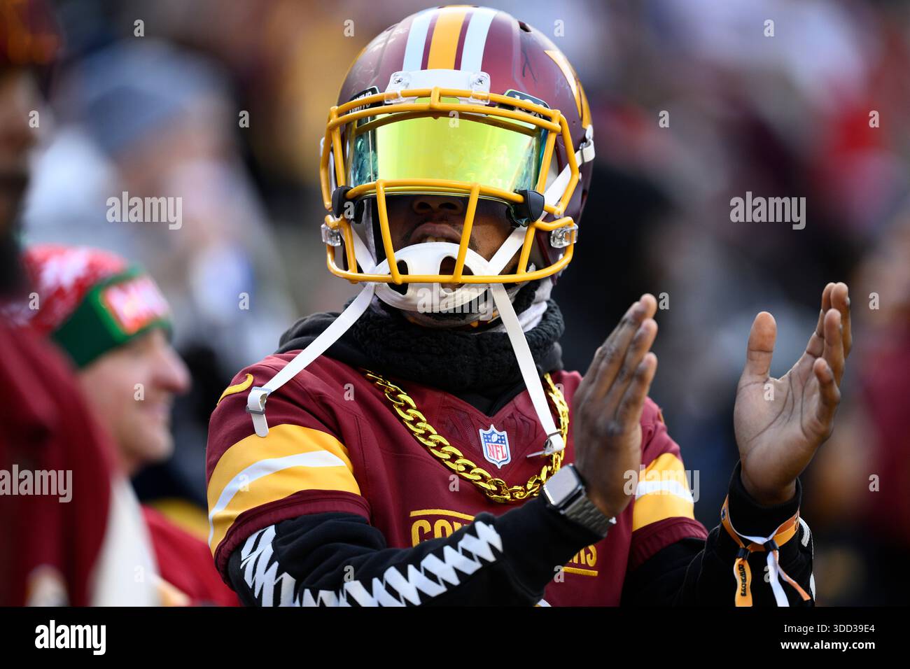 A spectator reacts during the second half of an NFL football game ...