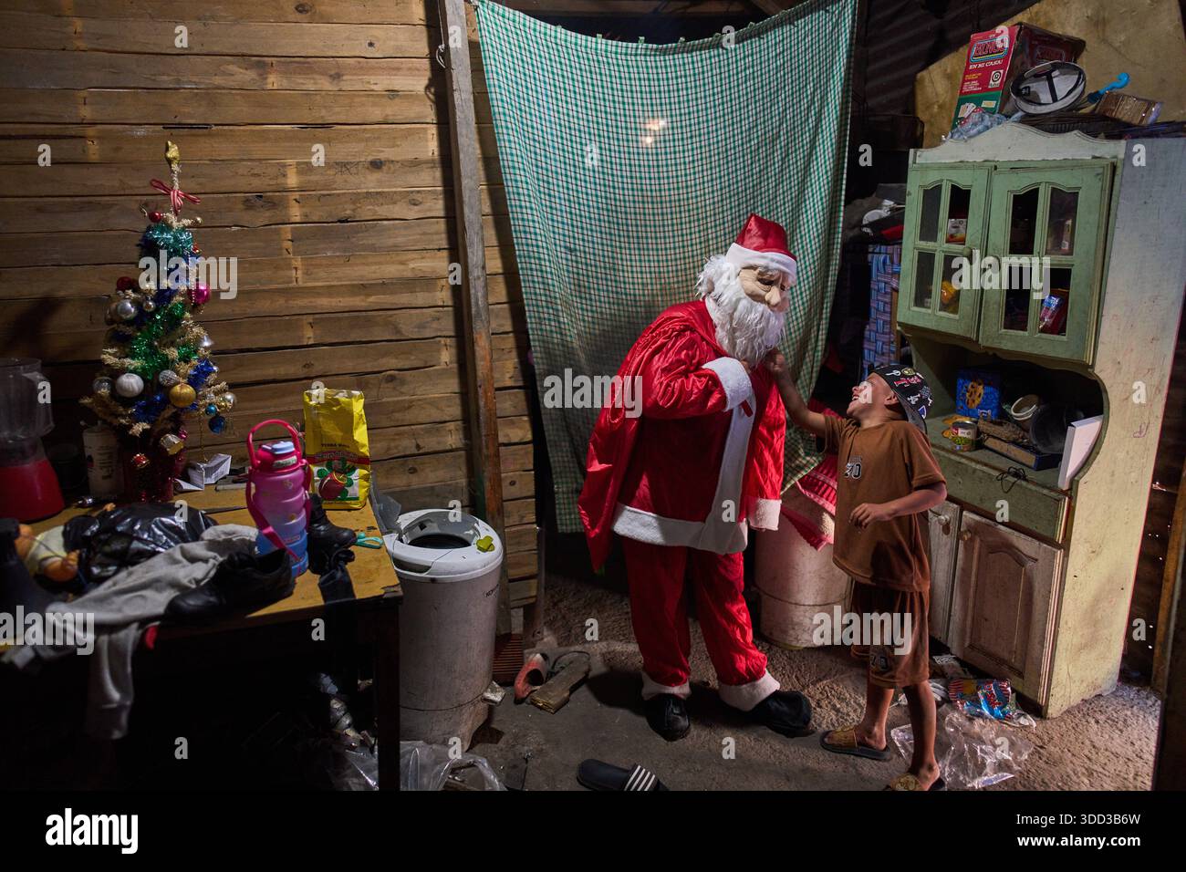 Cinthia Falcón, a neighbor dressed as Santa Claus, delivers gifts ...