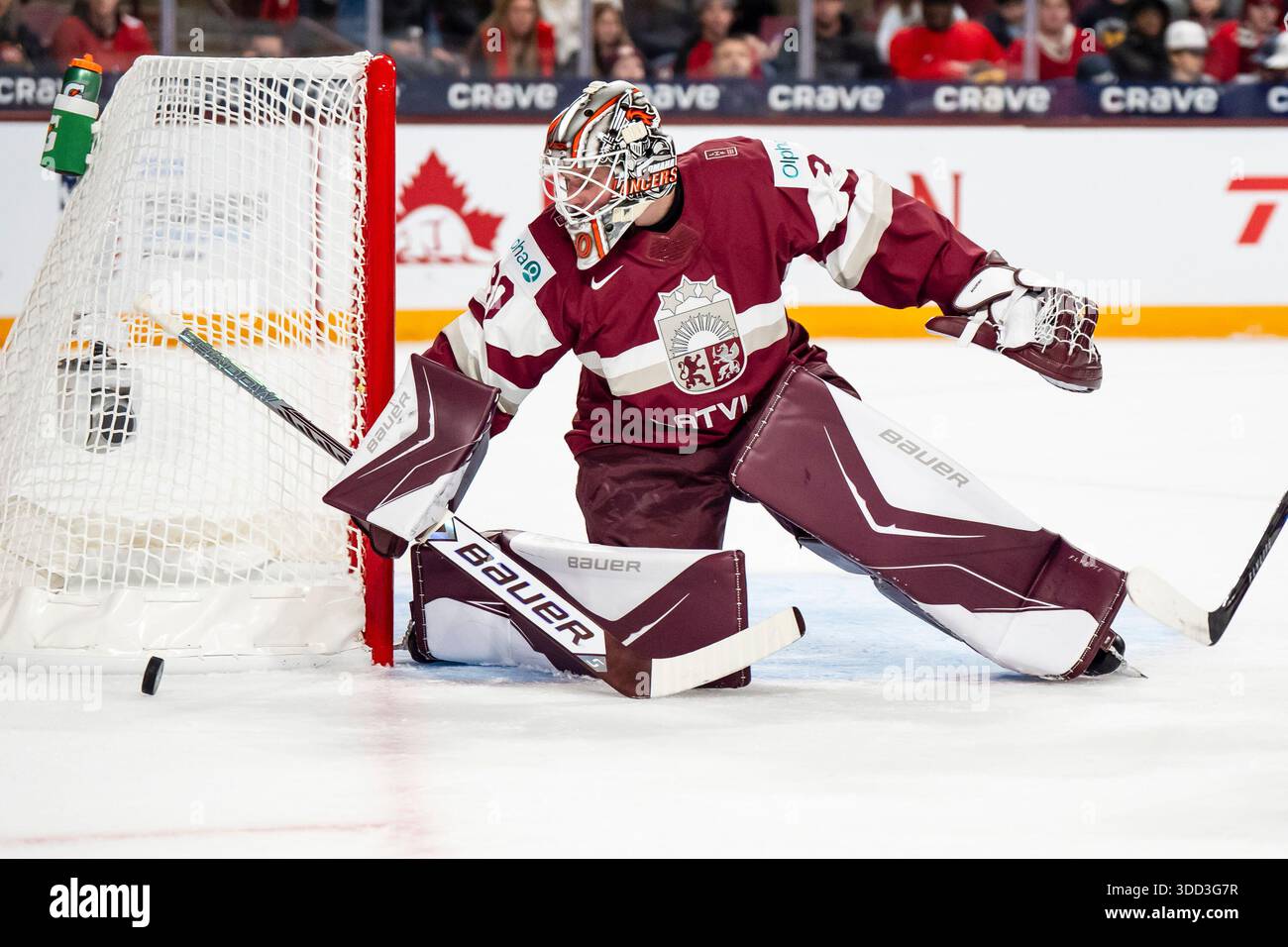 Latvia goaltender Nils Maurins (30) makes a save against Canada during ...