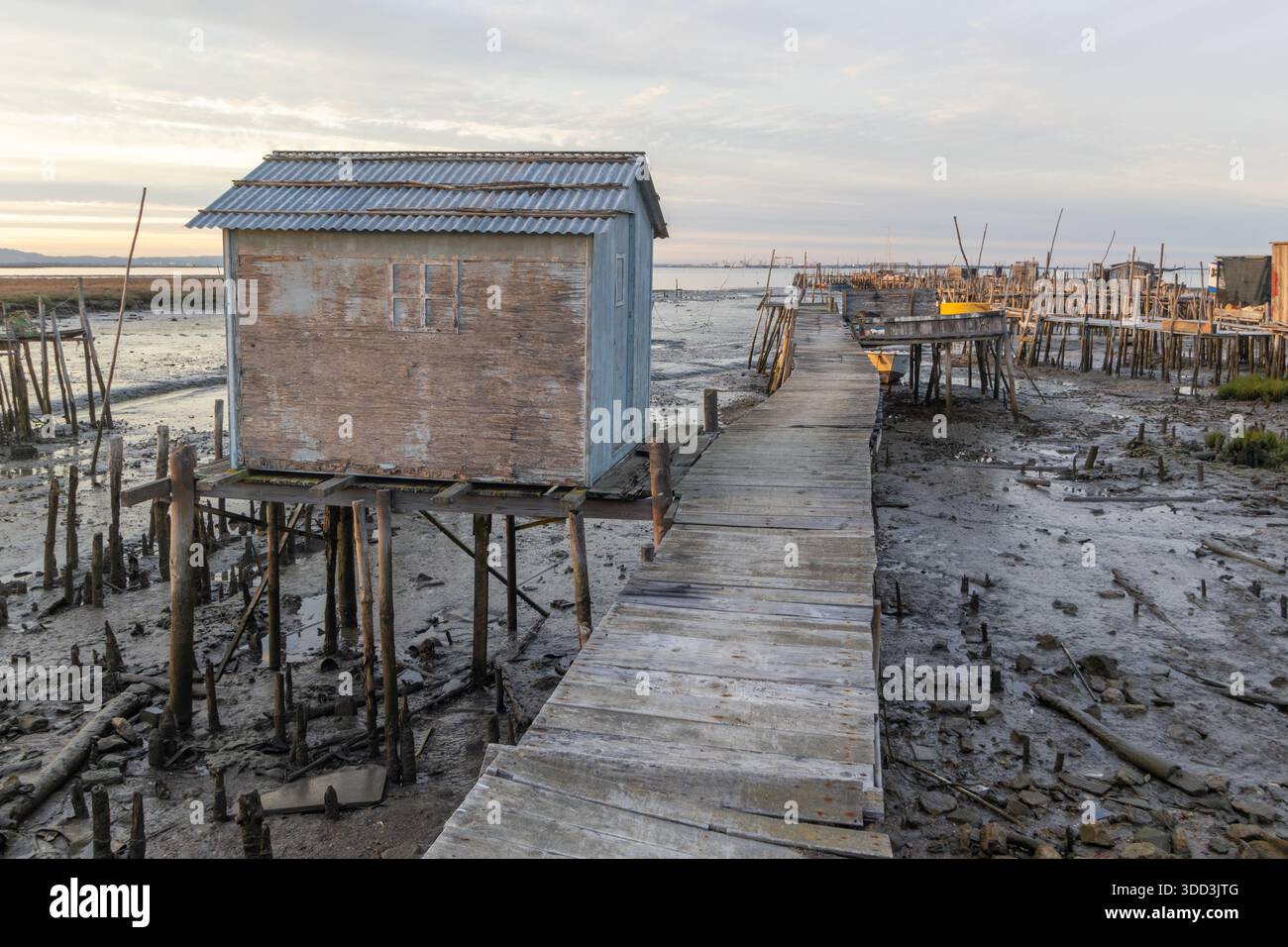 Rustic wooden fishing huts standing on stilts along a pier over the ...