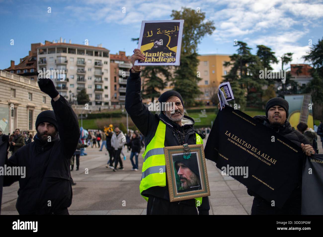 A man carries a photograph of the religious leader Abdullah Hashem ...