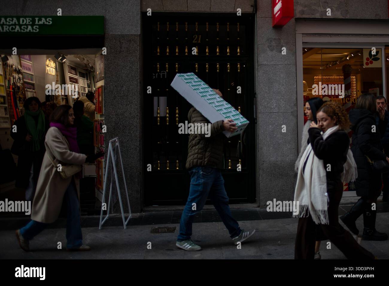 A man carries a gift box along Calle Preciados in Madrid. (Photo by ...