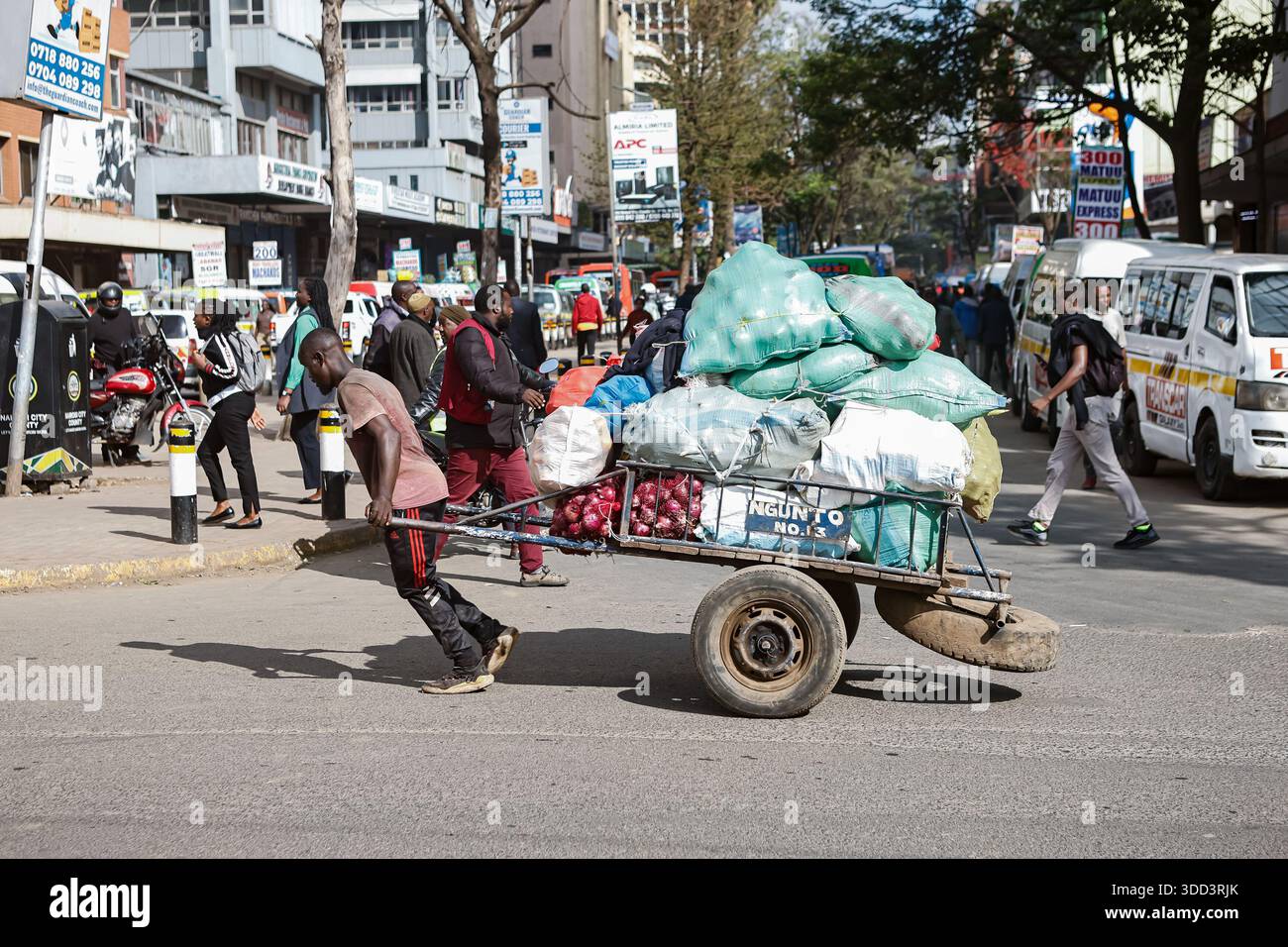 A Mkokoteni (cart) puller transport farm produce from the market to a ...
