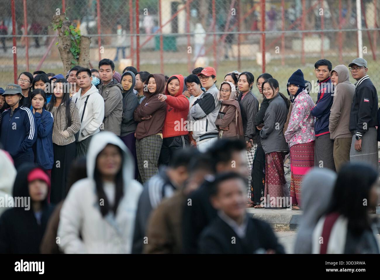 Voters line up to cast their ballots at a polling station in Naypyitaw ...
