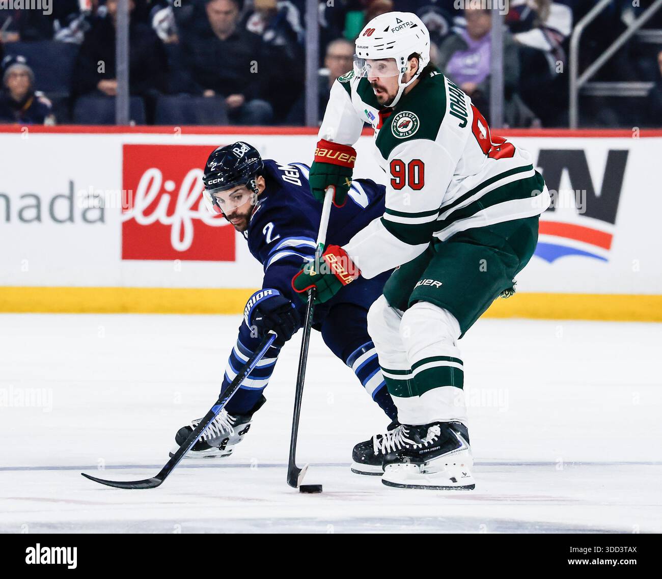 Winnipeg Jets' Dylan DeMelo (2) defends against Minnesota Wild's Marcus ...
