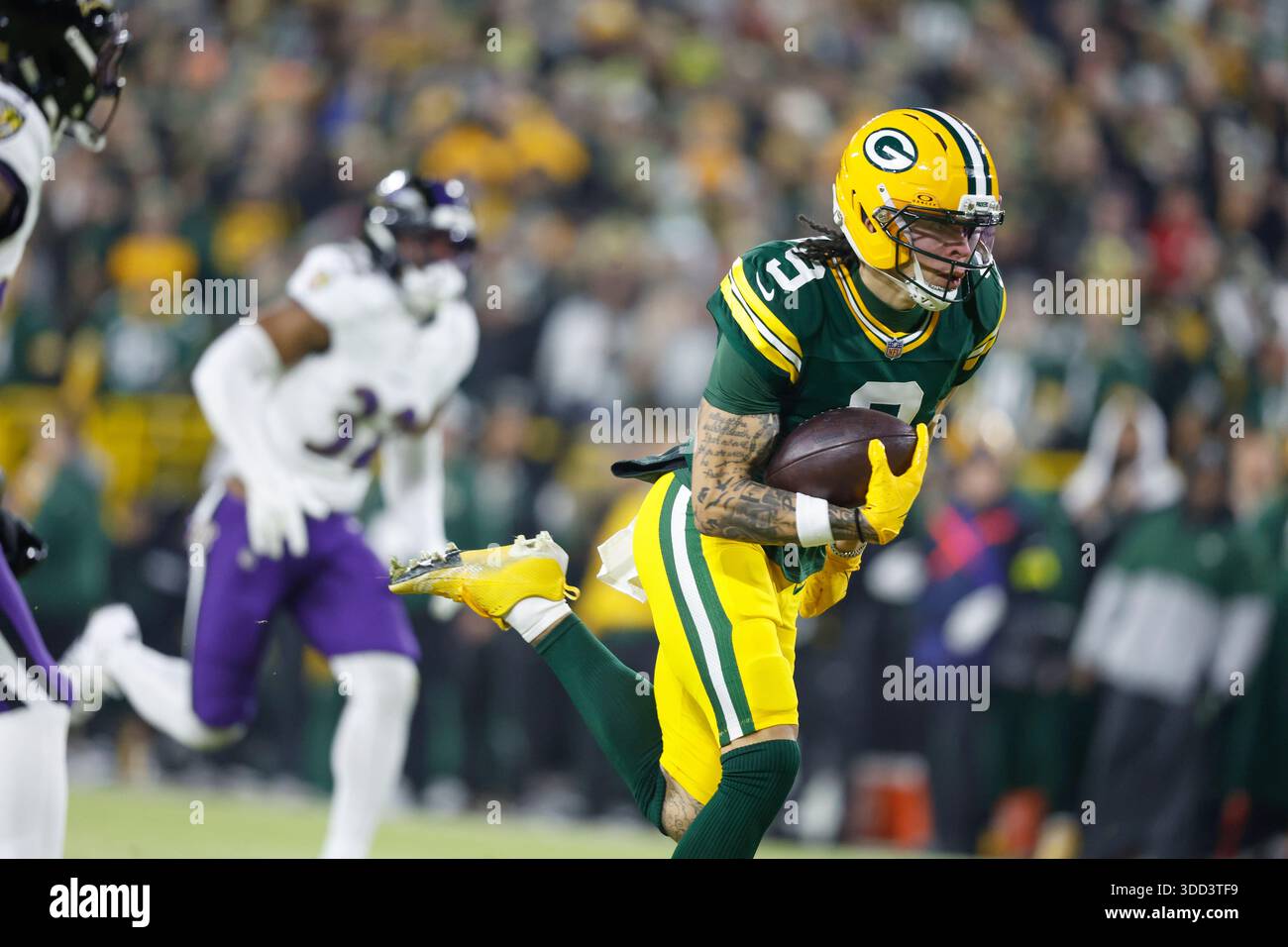 Green Bay Packers' Christian Watson runs in for a touchdown against the ...