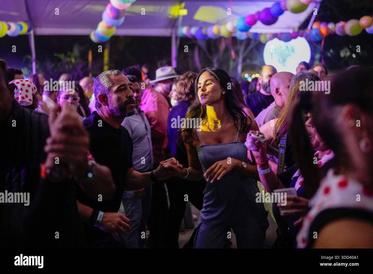 A couple dances salsa at a party in Caracas, Venezuela, Sunday, Dec. 28 ...