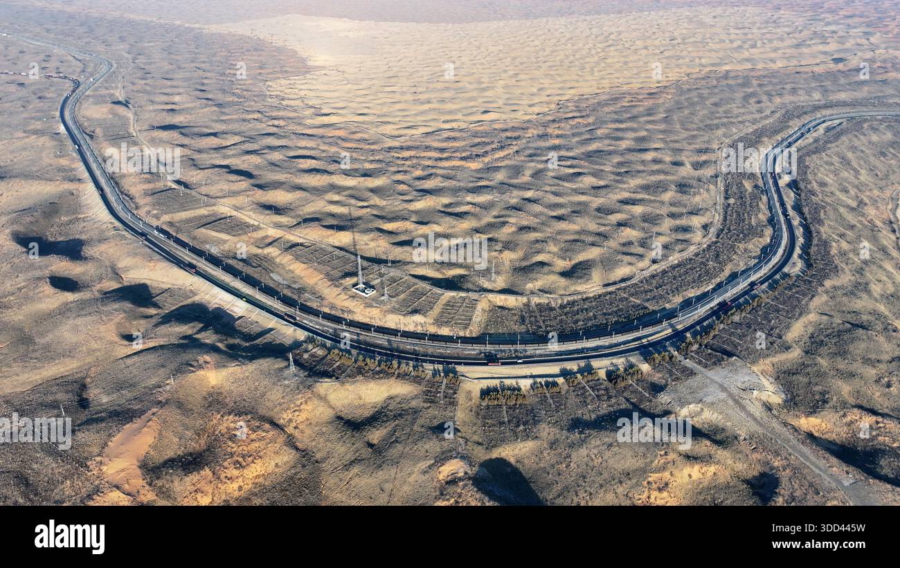 ZHONGWEI, CHINA - DECEMBER 27, 2025 - A train loaded with goods on the ...