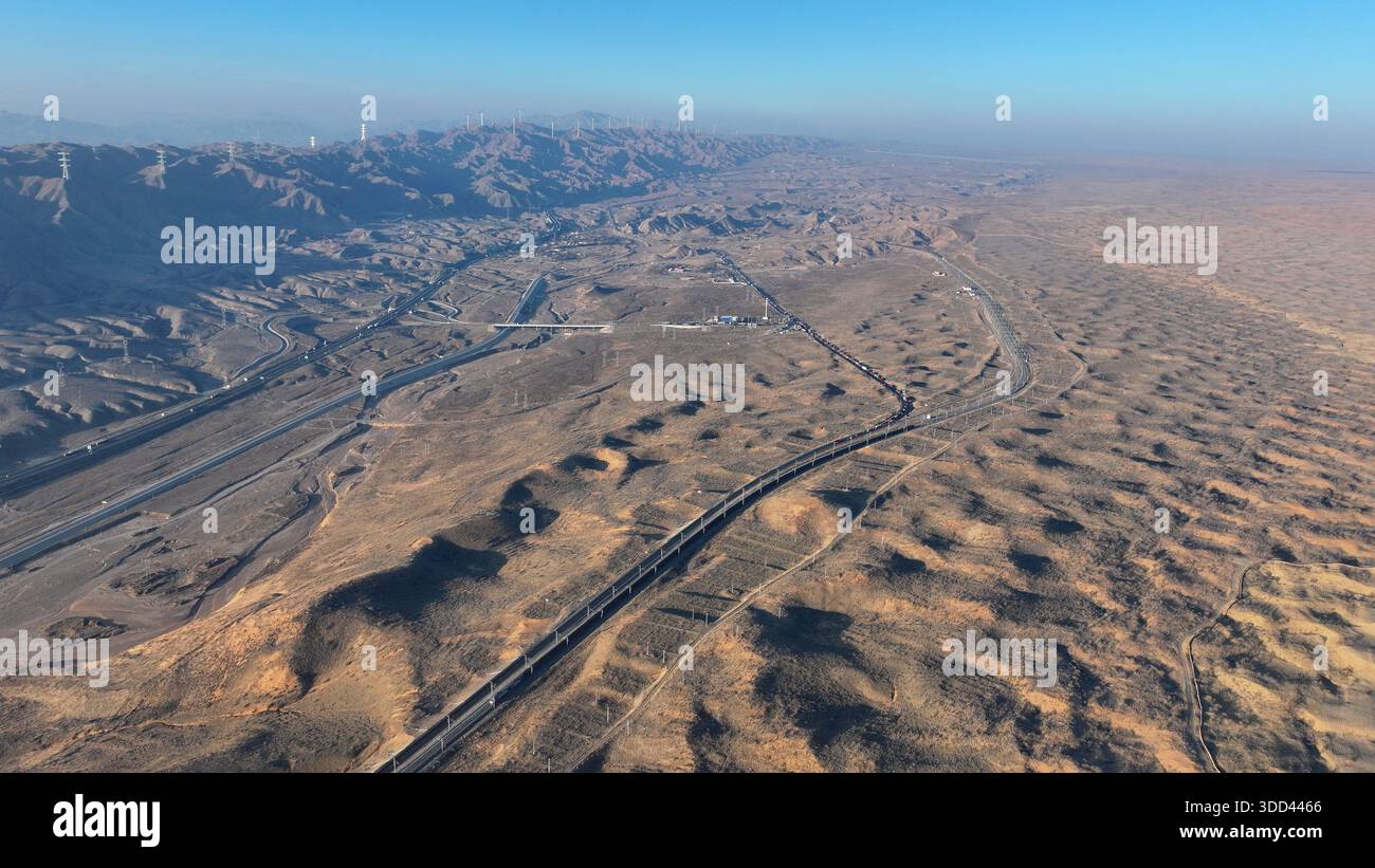ZHONGWEI, CHINA - DECEMBER 27, 2025 - A train loaded with goods on the ...