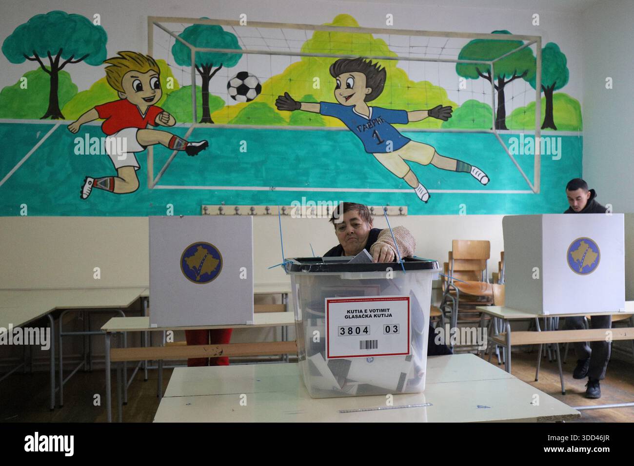A voter casts a ballot at a polling station in an early parliamentary ...