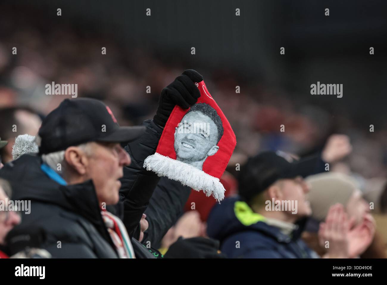 A fan holds up a Diogo Jota scarf during the Premier League match ...