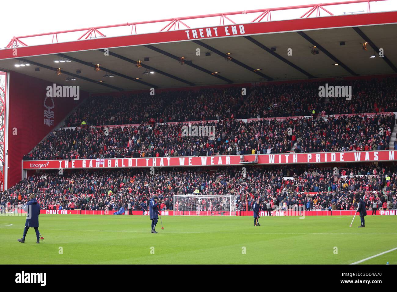 Groundsmen work on the pitch at the Nottingham Forest v Manchester City ...