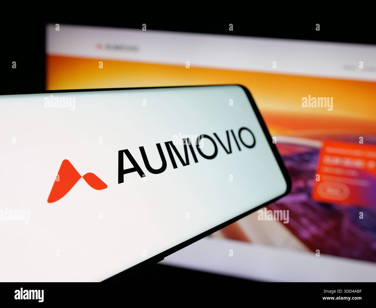 In this photo illustration, a smartphone with the logo of automotive ...