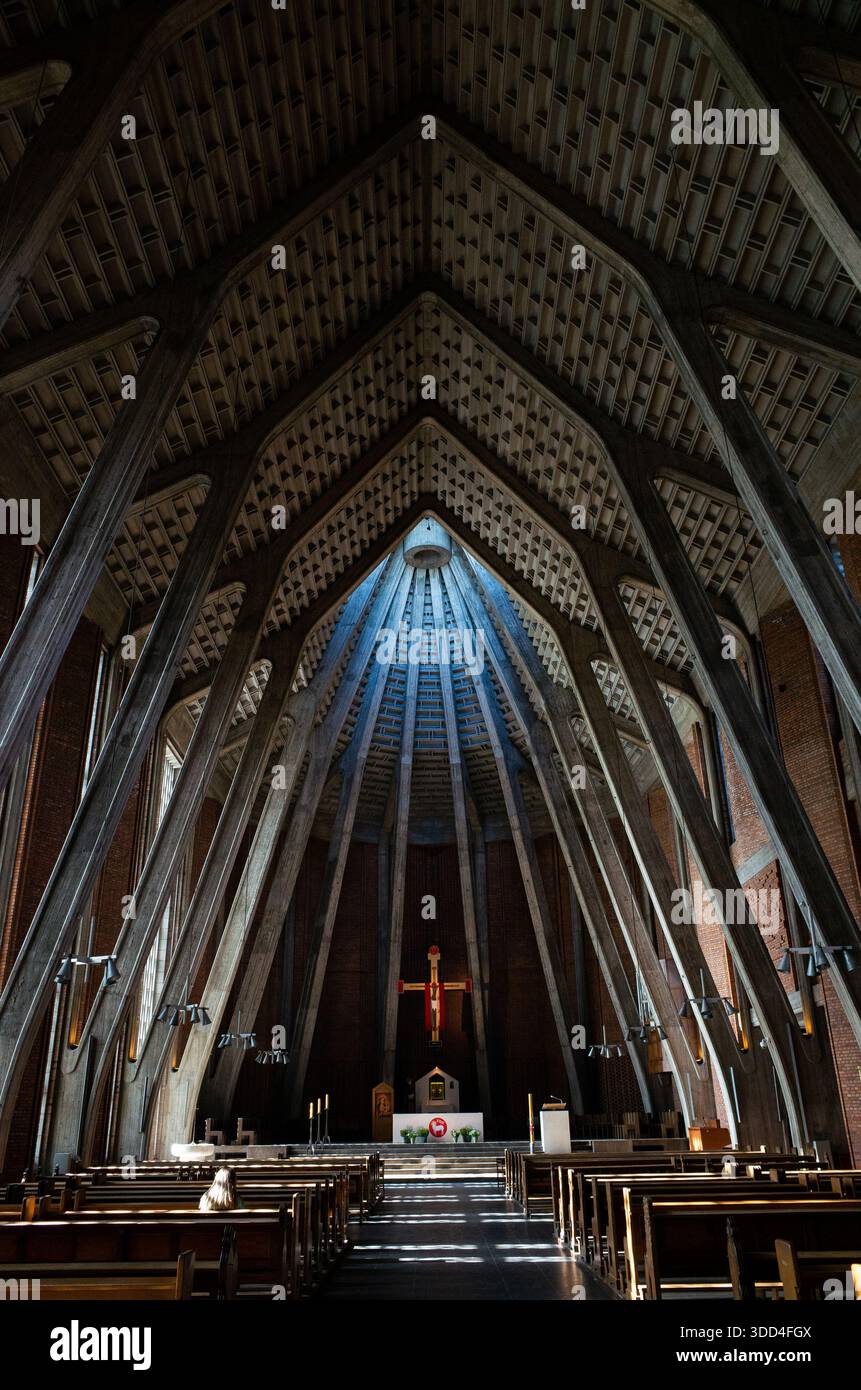 Interior of a modern church with dramatic concrete arches, wooden ...