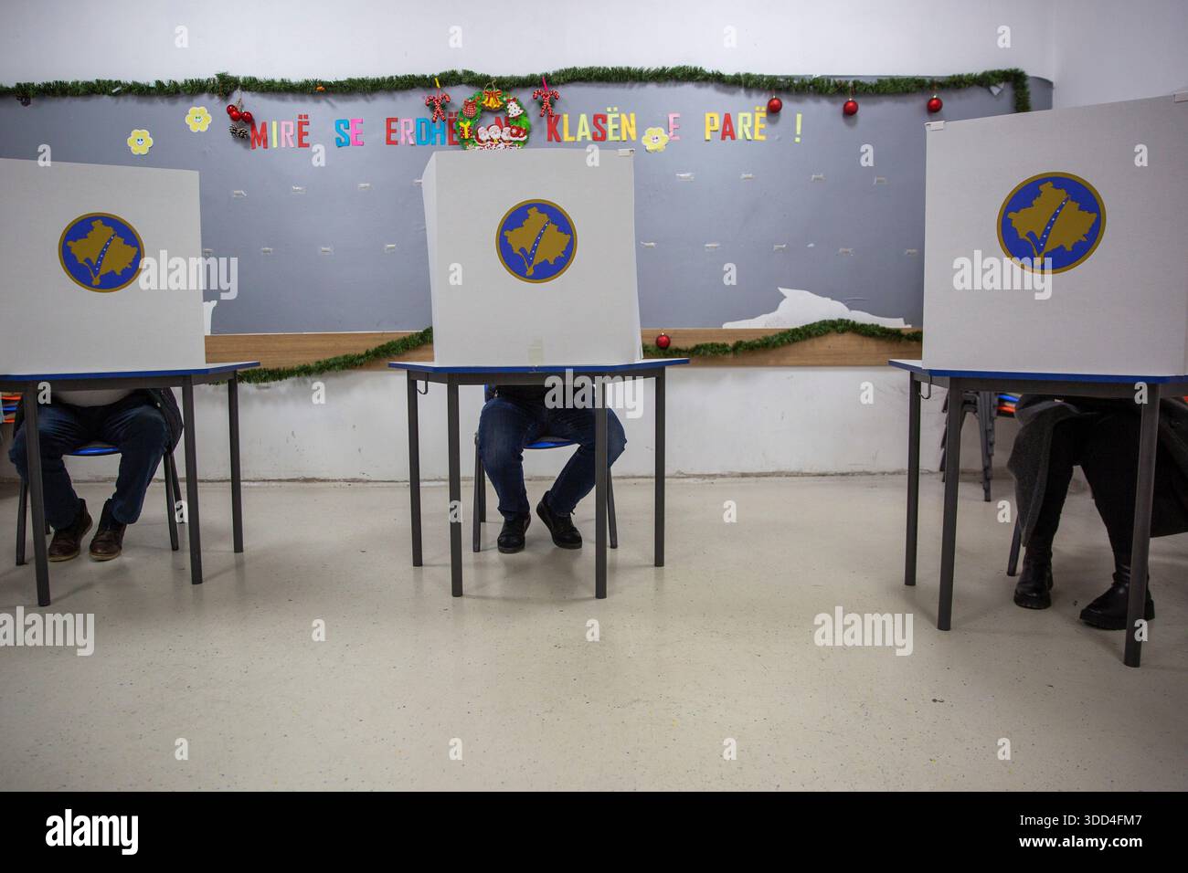 Voters fill their ballots behind voting booths for early parliamentary ...
