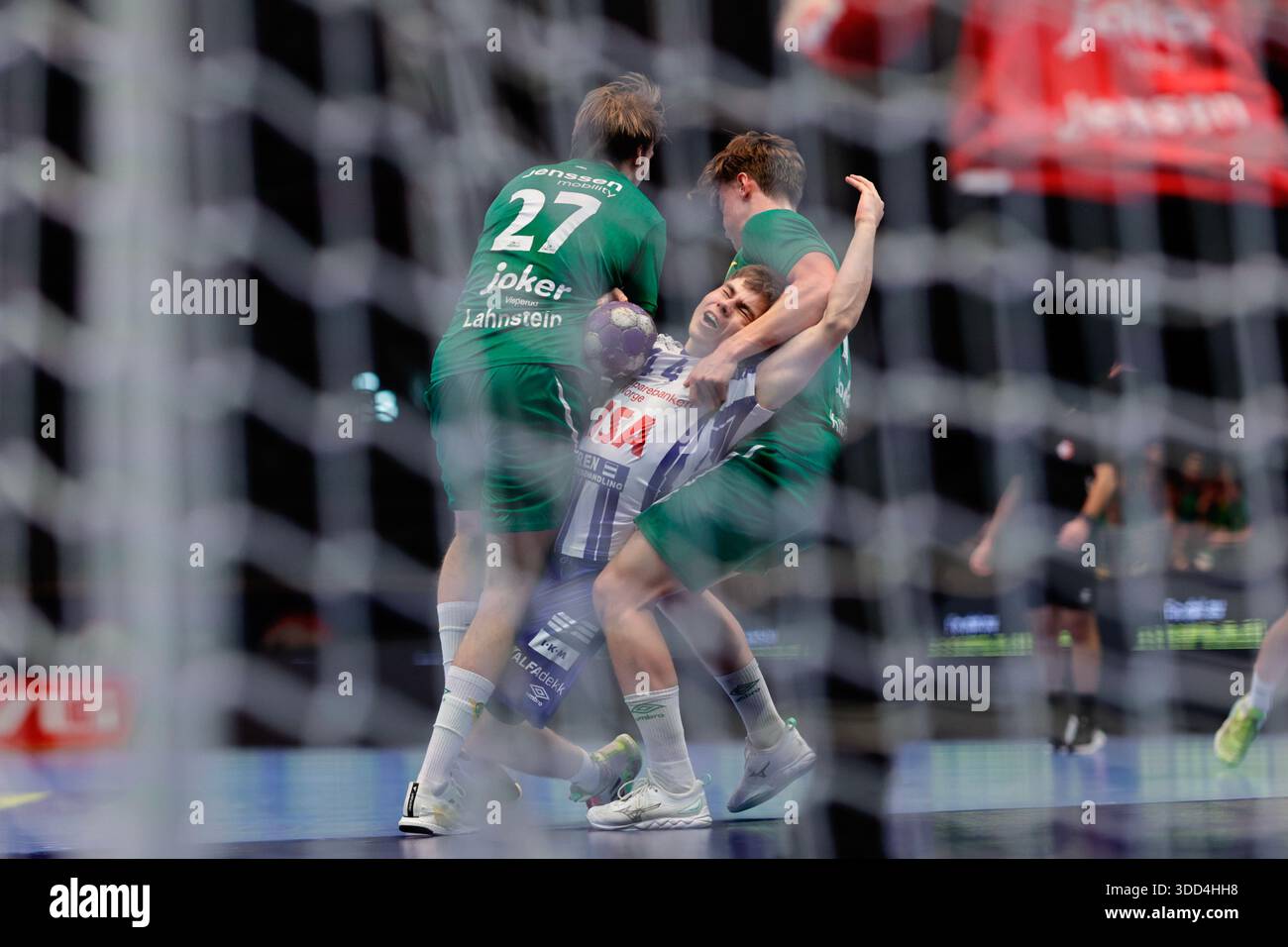 Fornebu 20251228. Nærbø's player Jonas Gudmestad is held by Fjellhammer ...