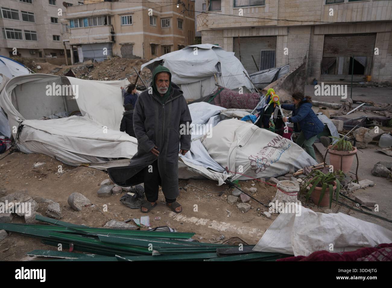 Palestinian members of the Al-Ajouri family stand by their tent that ...