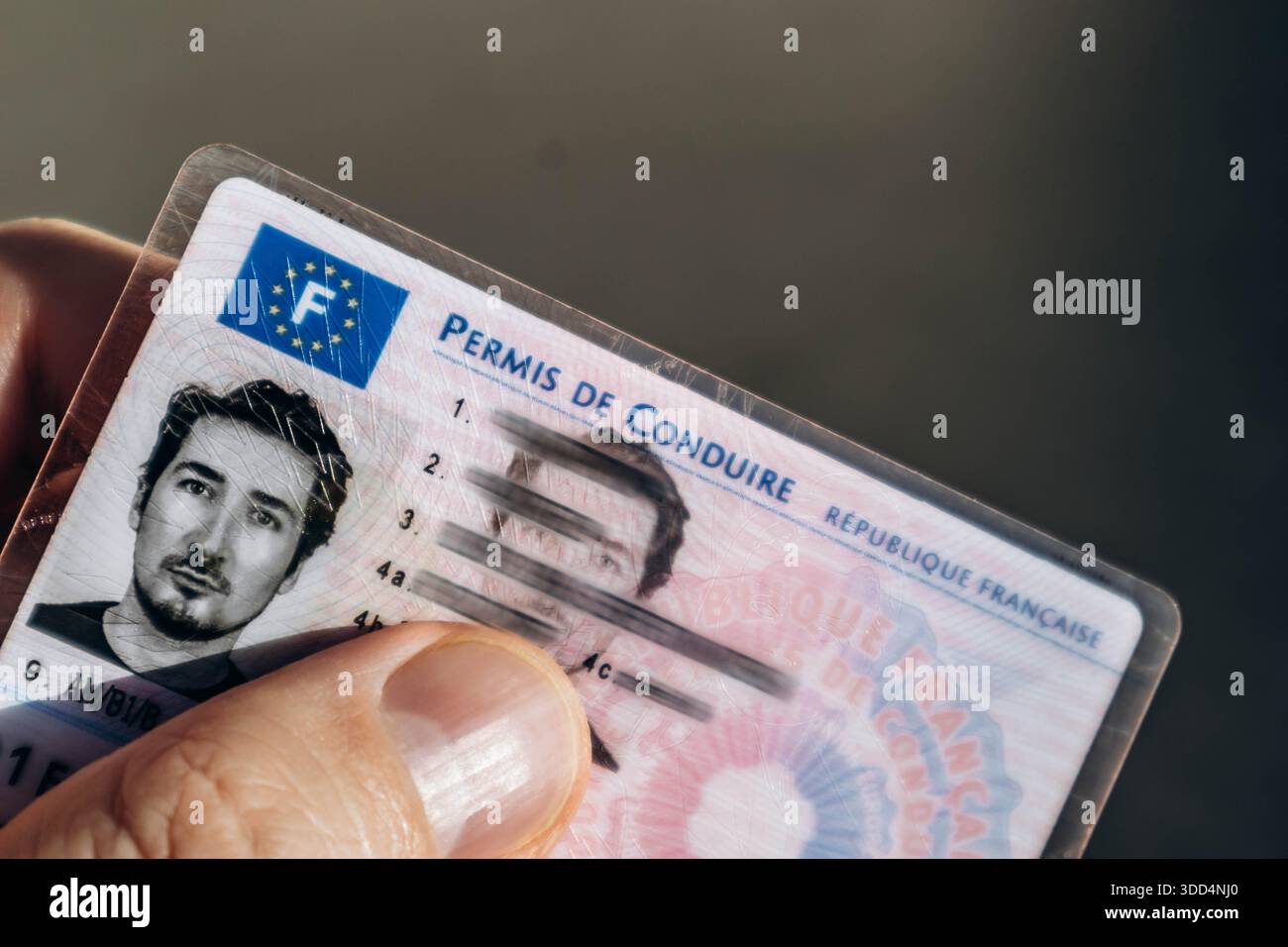 Nice, France - December 9, 2025: French driving license held in a male ...