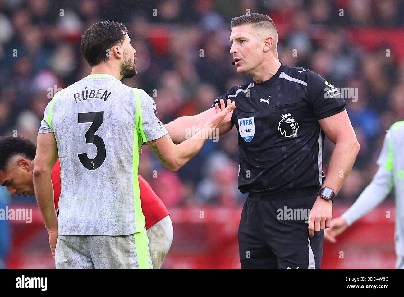 Referee Robert Jones talks with Ruben Dias of Manchester City during ...