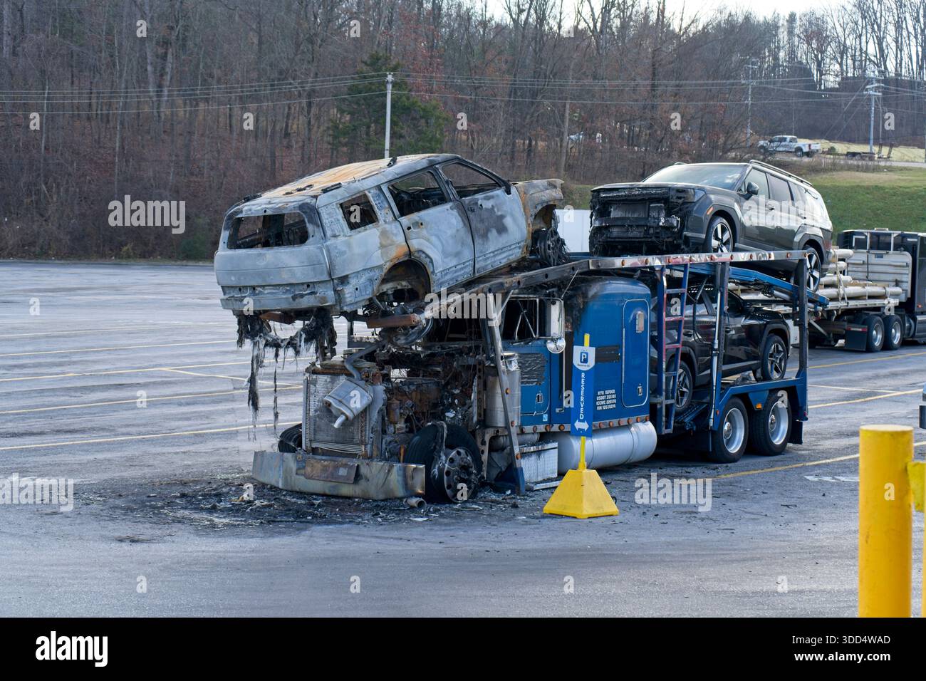 Destroyed car carrier semi truck with burnt SUVs in parking lot after ...