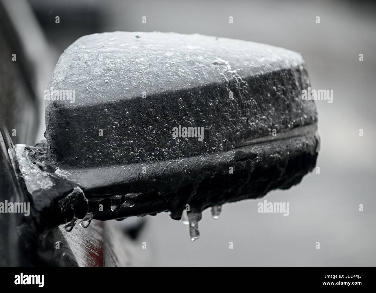 Ice is shown on the side mirror of a car in Montreal, Sunday March 30 ...