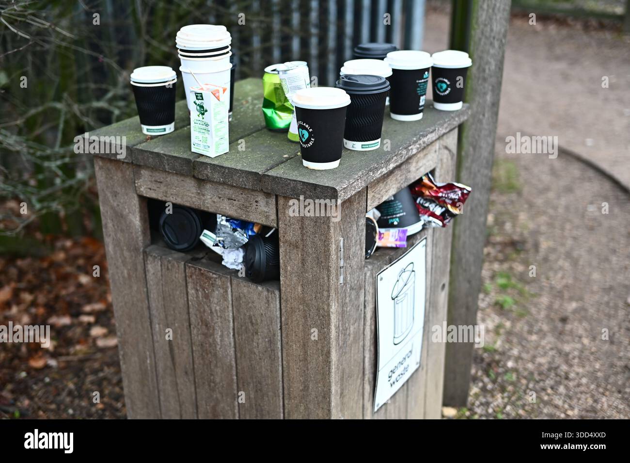 Recycled food and drink packaging on over filled general waste bin ...