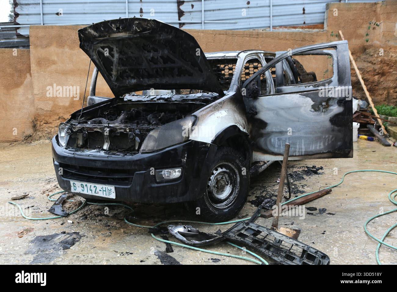 A view of a burnt Palestinian car seen after Israeli settlers set fire ...