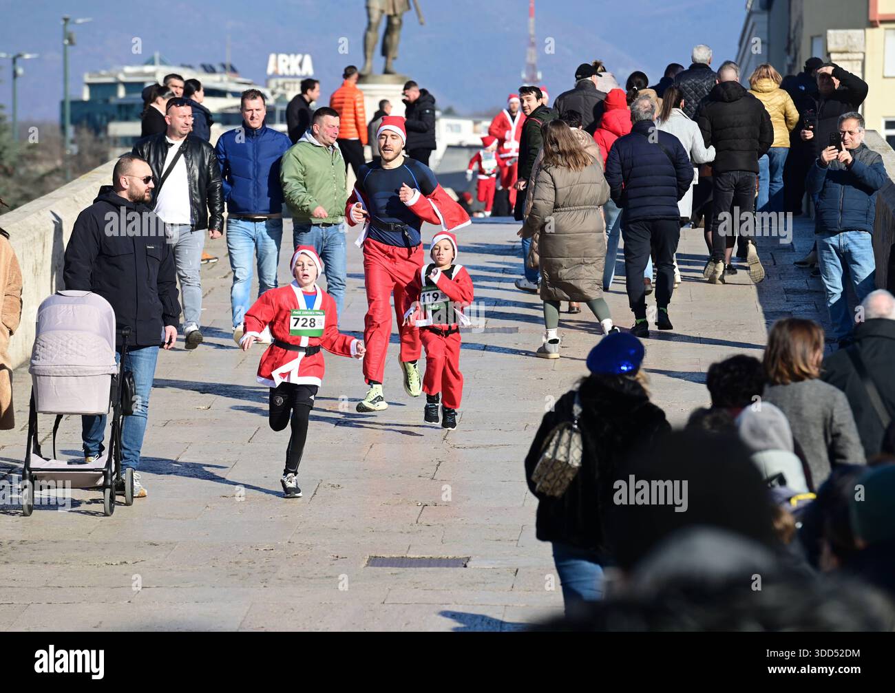 Participants dressed as Santa Clauses run during the traditional Santa ...
