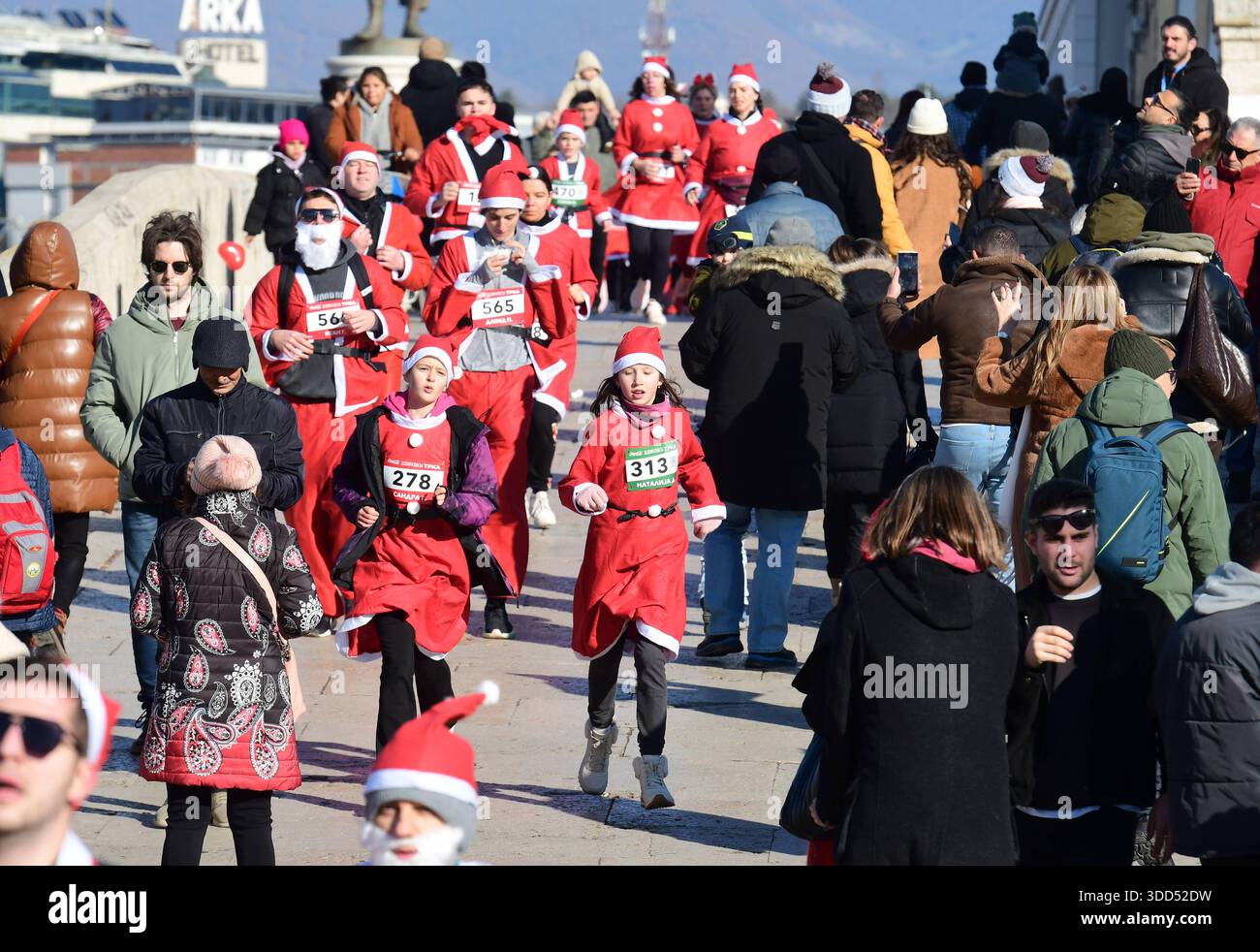 Participants dressed as Santa Clauses run during the traditional Santa ...