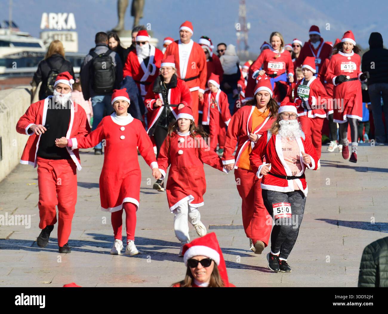 Participants dressed as Santa Clauses run during the traditional Santa ...