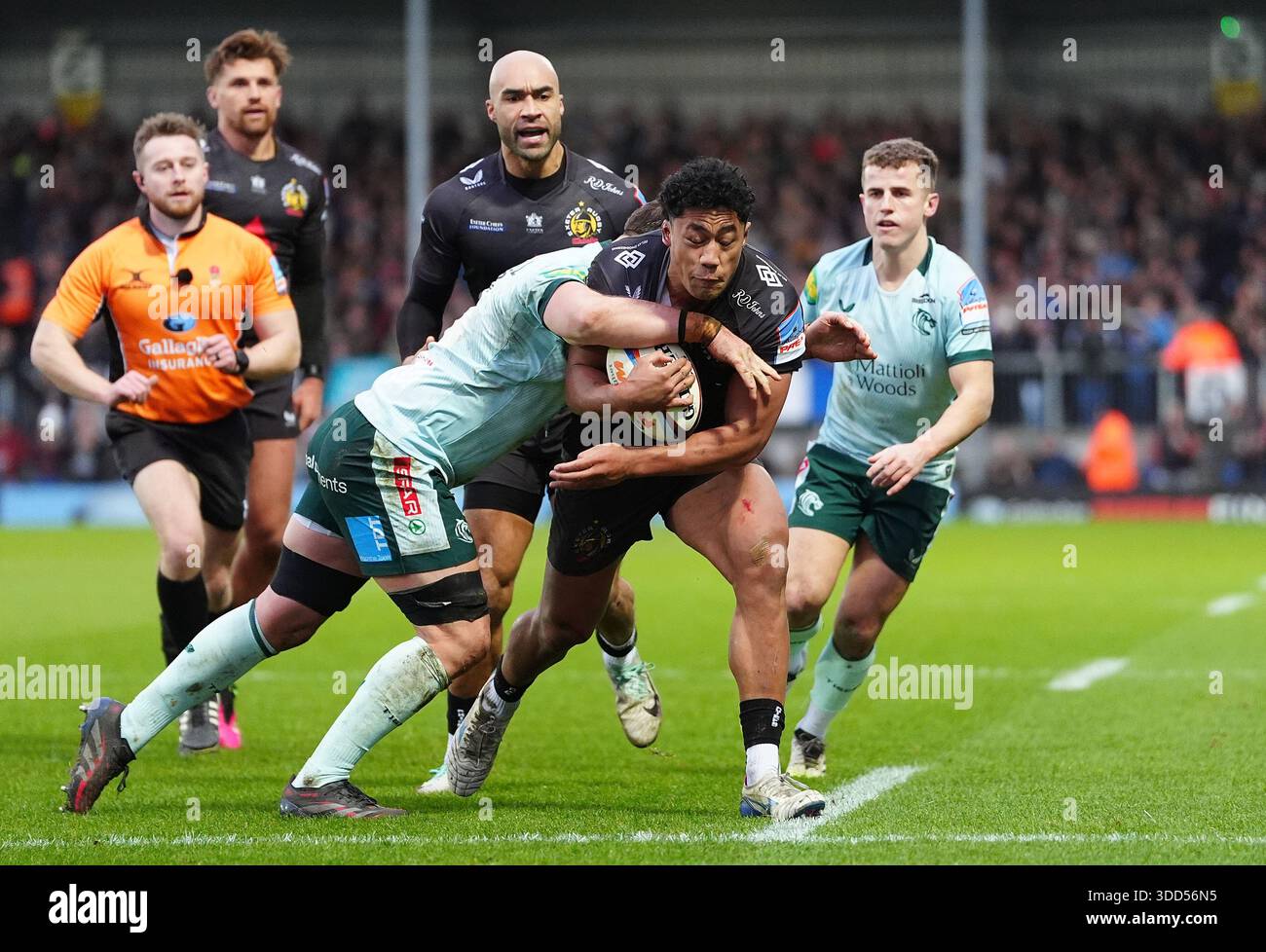Exeter Chiefs' Greg Fisilau (centre right) is tackled by Leicester ...