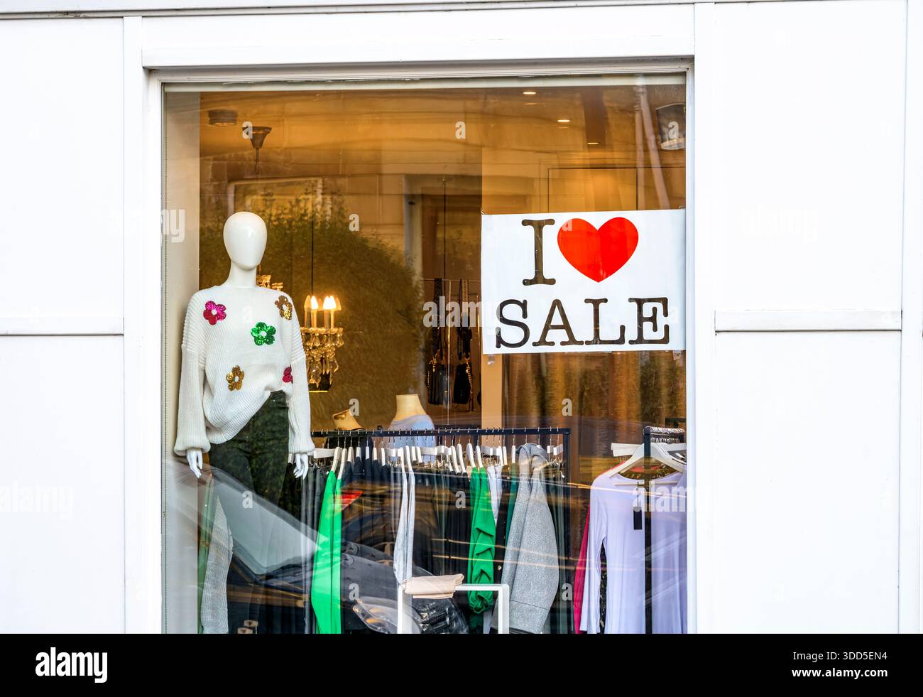 Sale sign in a clothes shop window, UK Stock Photo - Alamy