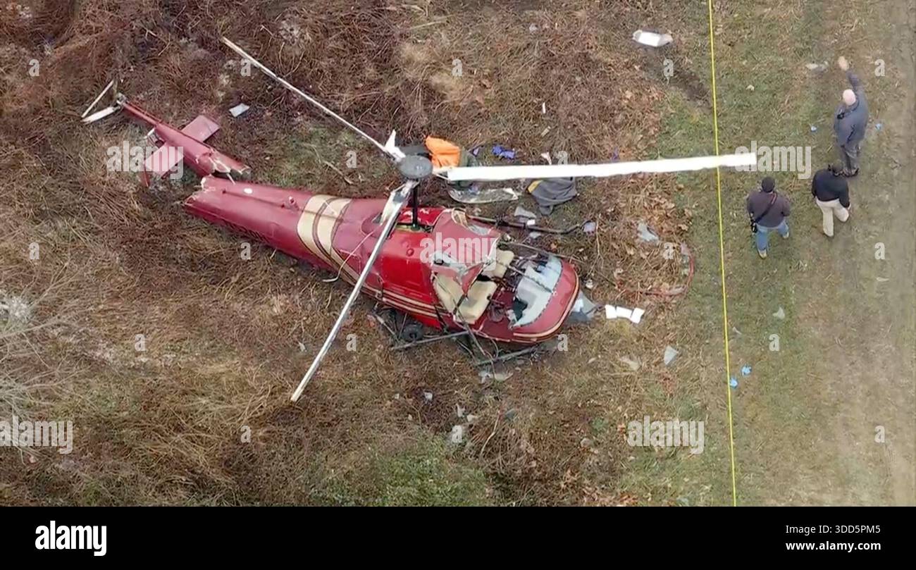 Authorities look over the scene after two helicopters crashed in ...