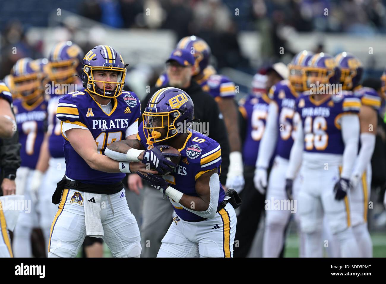 East Carolina quarterback Chaston Ditta warms up before the Military ...