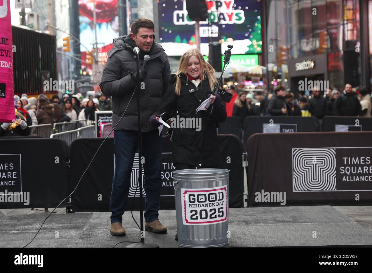 Host Jonathan Bennett, left, looks on while a participant rips up a ...