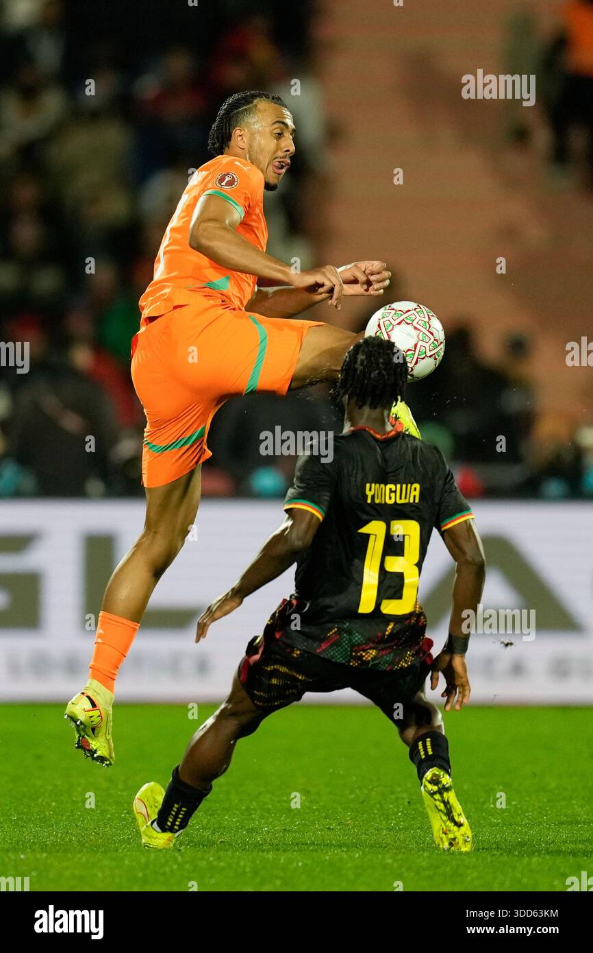 Ivory Coast's Guela Doue is challenged by Cameroon's Darlin Yongwa ...