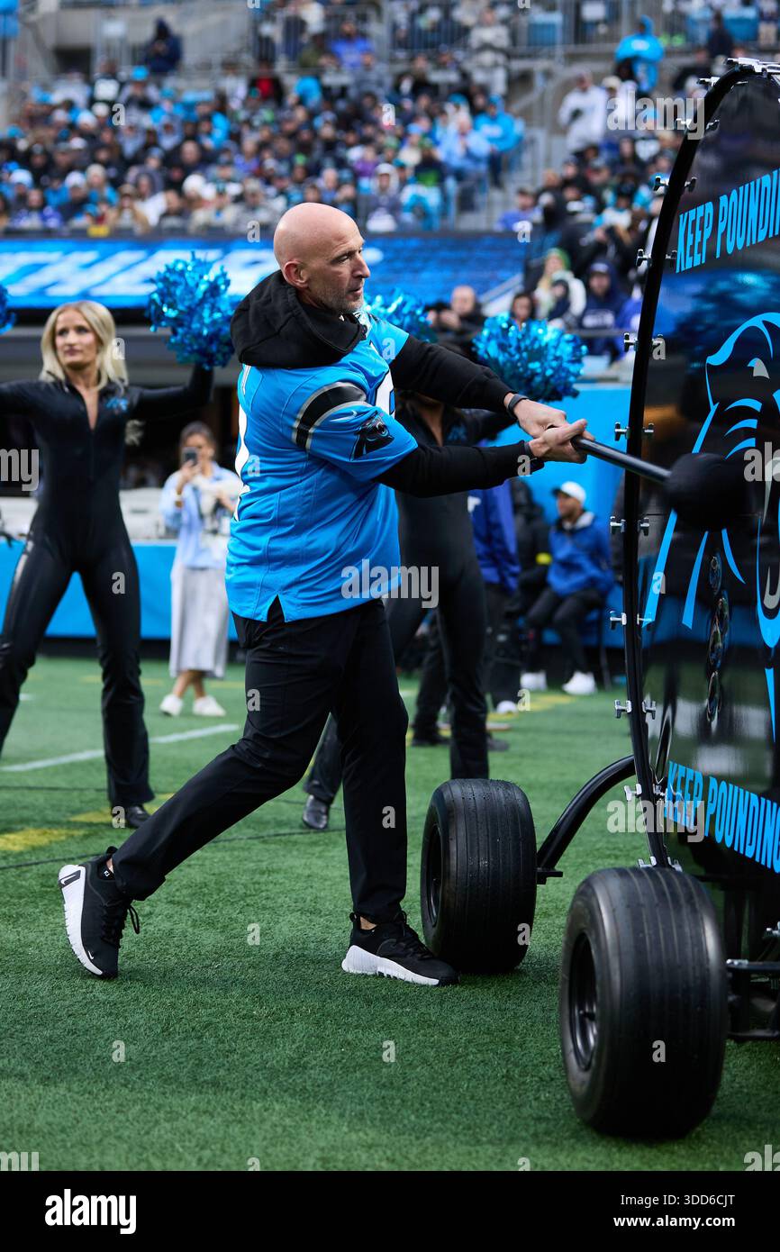 Former Carolina Panther Ricky Proehl hits the Keep Pounding drum during ...