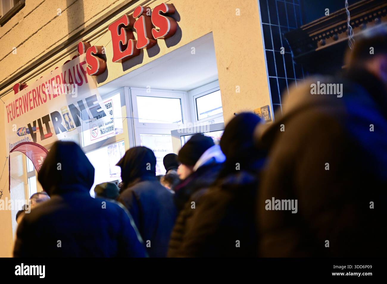 29 December 2025, Berlin: Customers queue in front of a fireworks ...