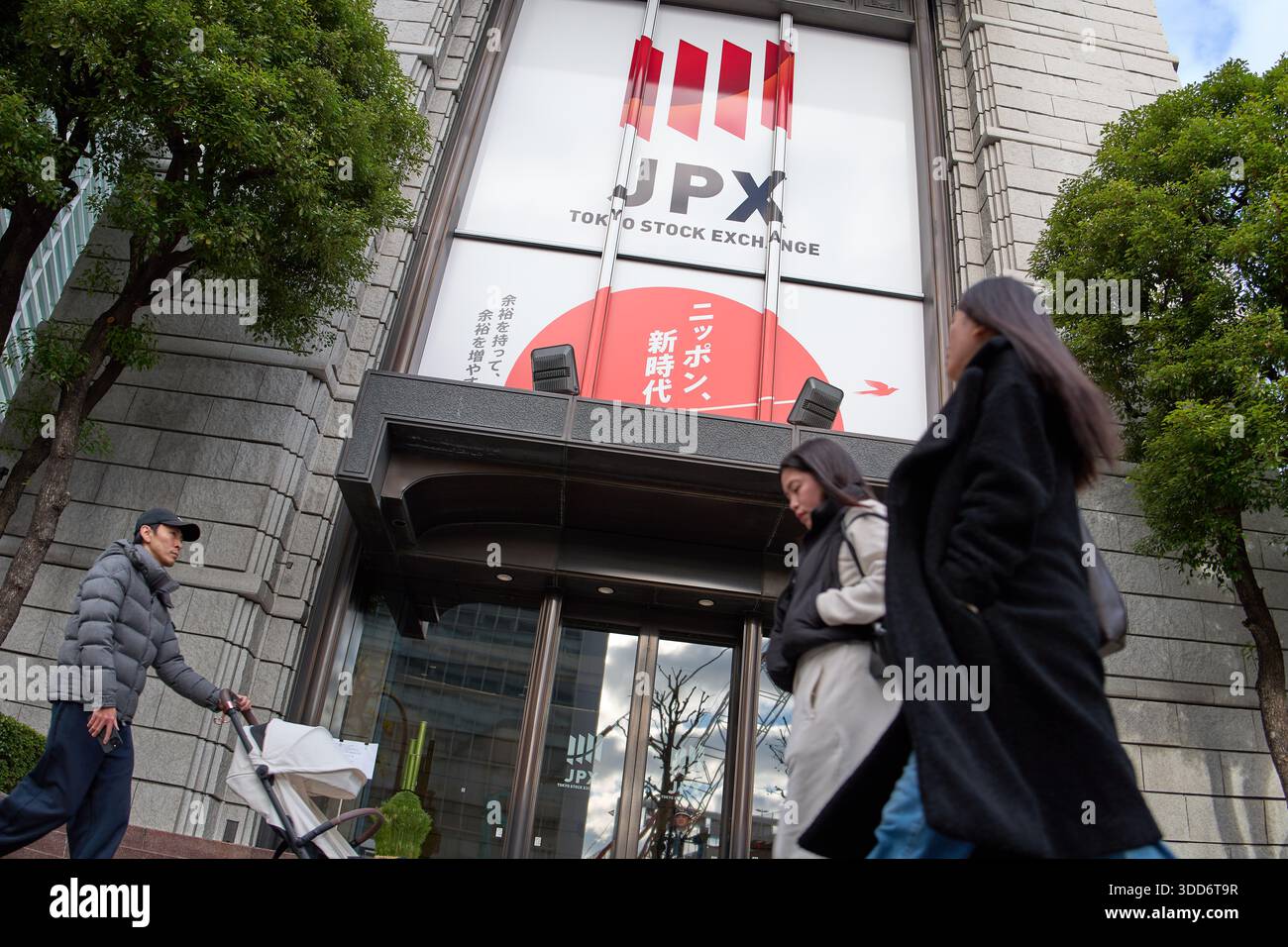 People walk in front of Tokyo Stock Exchange building, Monday, Dec. 29 ...