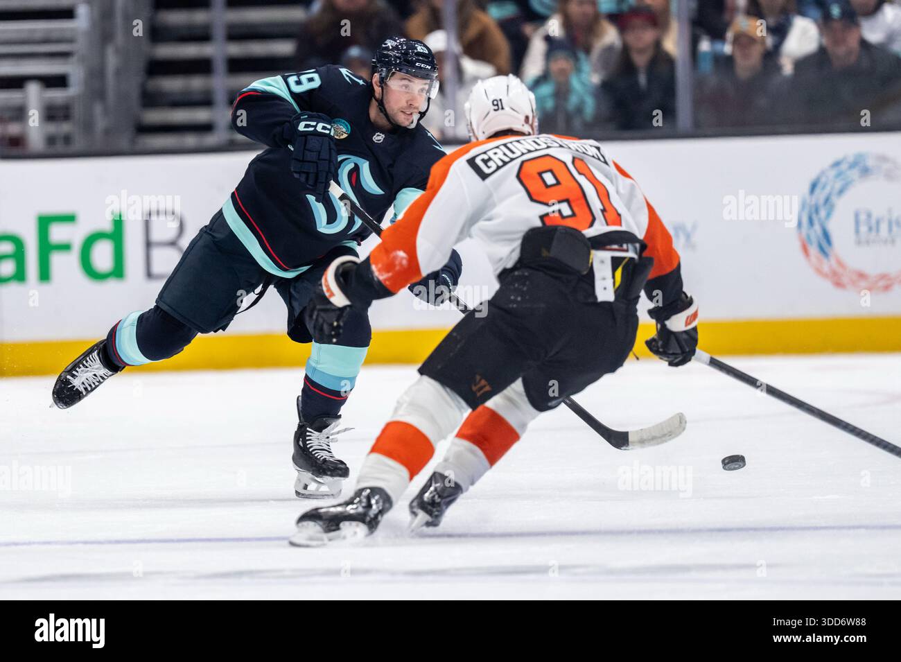 Seattle Kraken defenseman Vince Dunn, left, passes the puck against ...